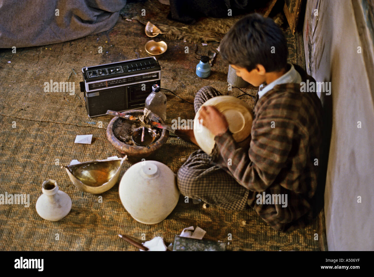 Boy smoothing paper mache before printin Stock Photo - Alamy