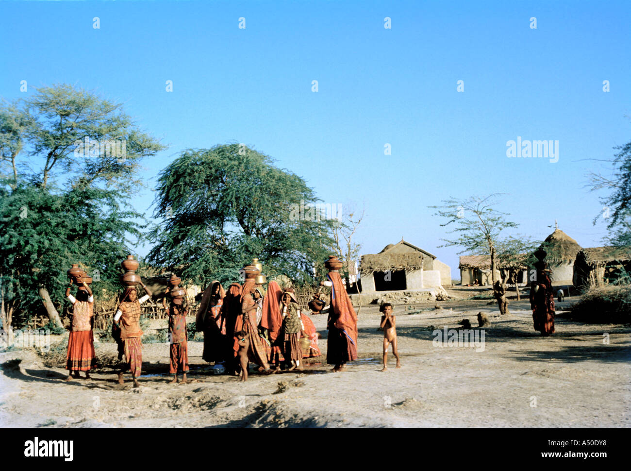 Rural women carrying water pots hi-res stock photography and images - Alamy