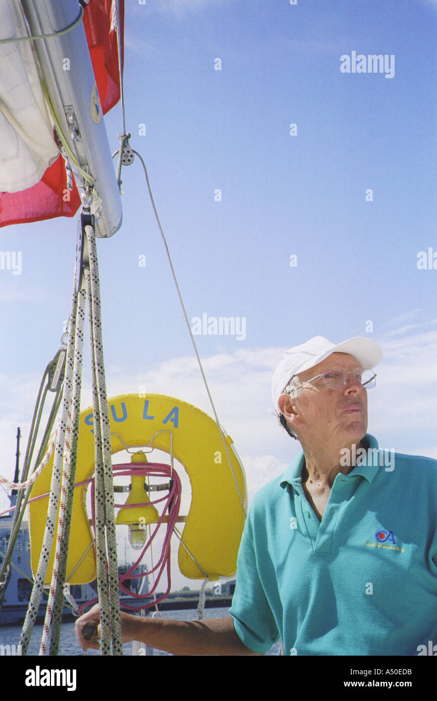 Man at the helm of Sailing Yacht Stock Photo - Alamy