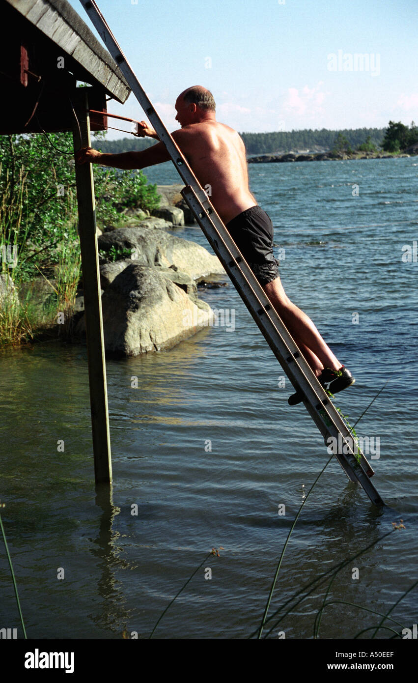 Man standing on water ladder hi-res stock photography and images - Alamy
