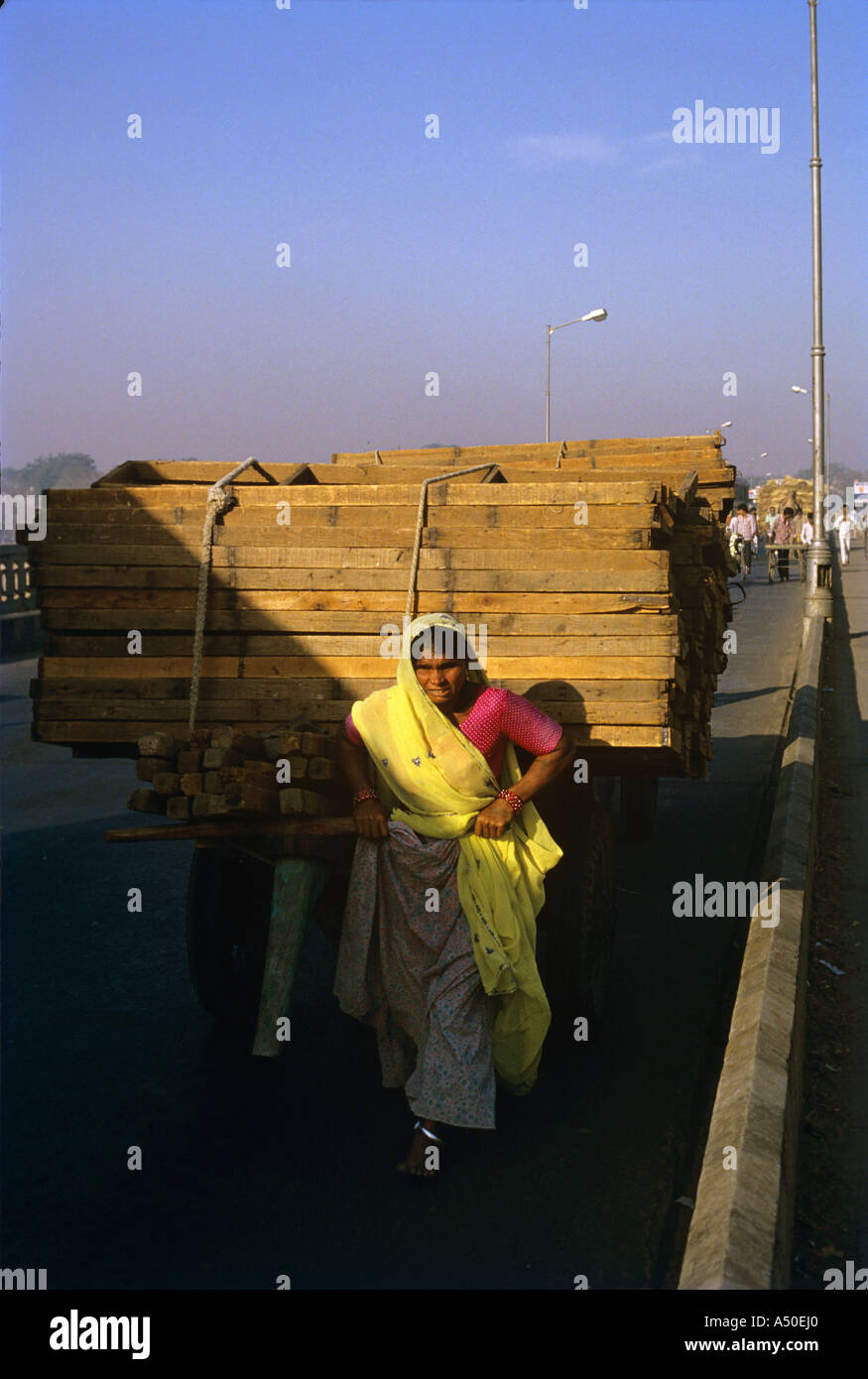 Woman pulling a cart Stock Photo - Alamy