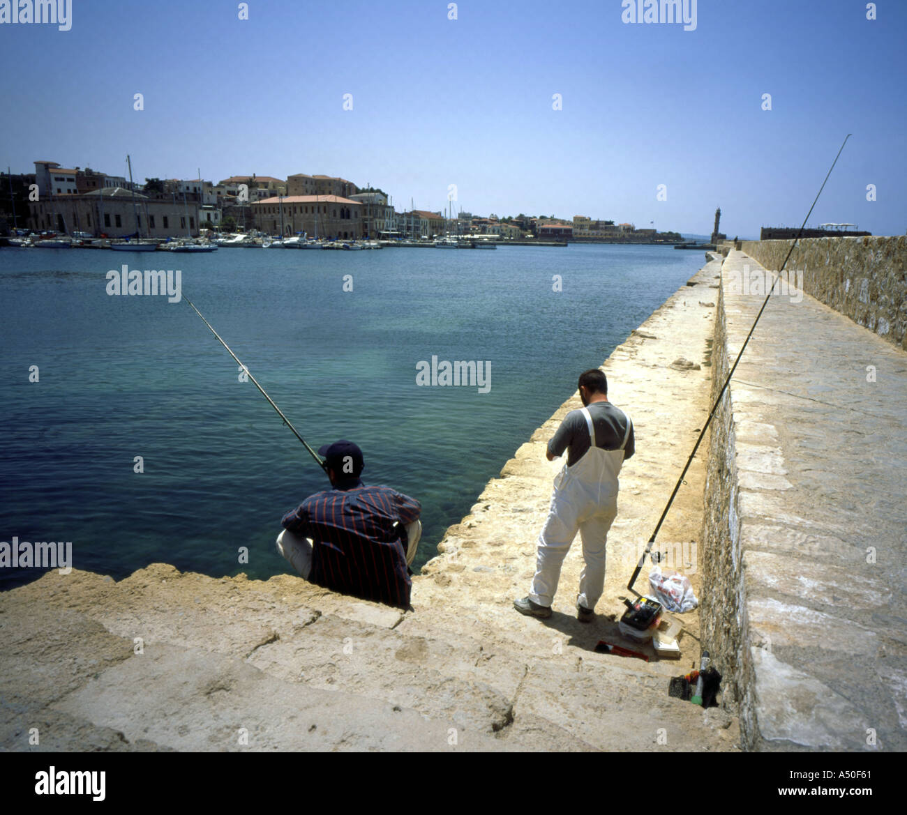 Chania Harbour in Crete. Locals fishing Chania harbour Crete Greece ...
