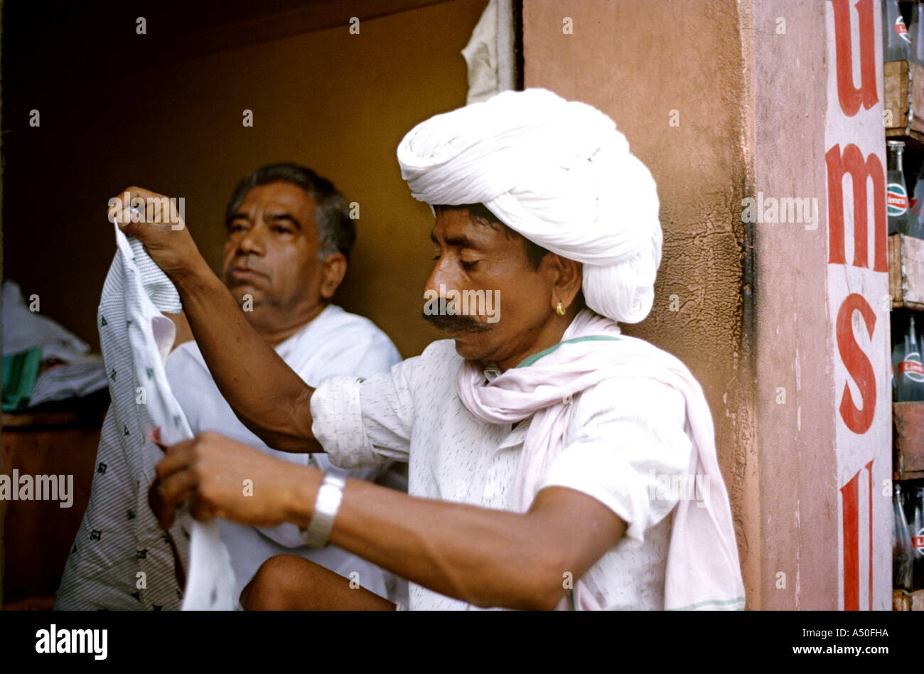 Local Gujarati men sitting outside a shop Stock Photo - Alamy