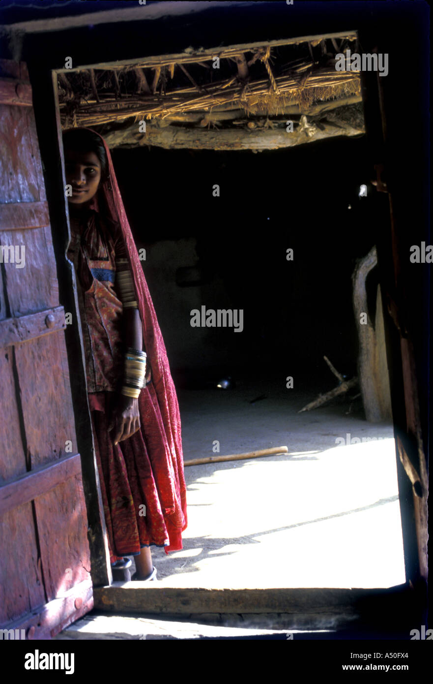Woman standing on the gate of a hut Gujarat India Stock Photo - Alamy