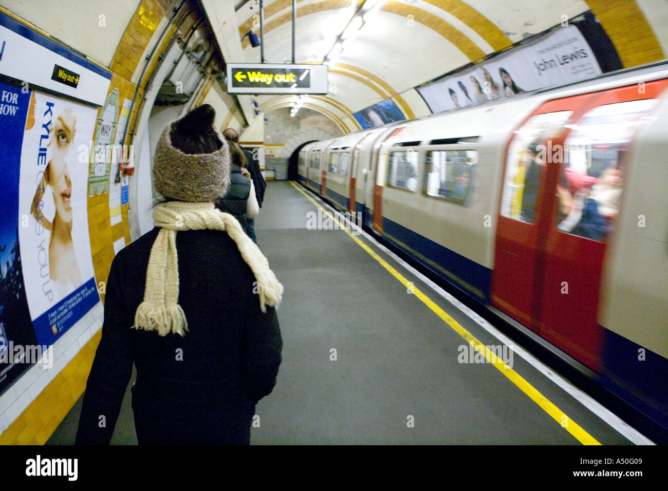 Moving Tube train and commuters London England Stock Photo - Alamy
