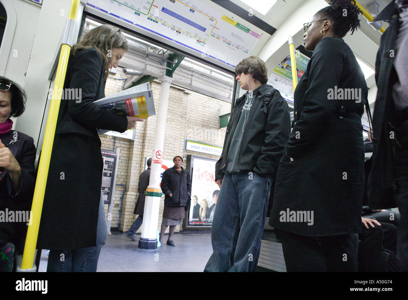 Tube train and commuters at a station London England Stock Photo - Alamy