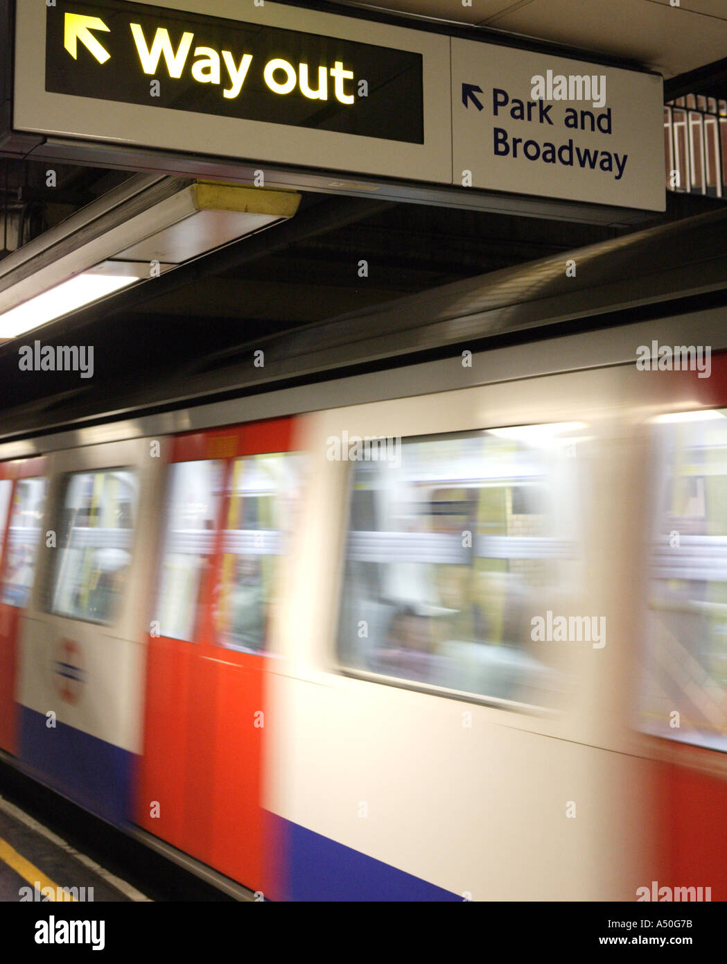 Tube train speeding into a station London England Stock Photo - Alamy