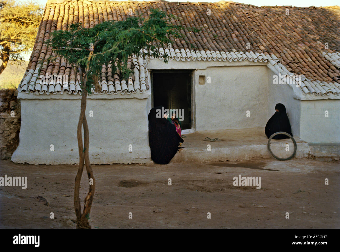 Rahari women sitting outside a hut at Ku Stock Photo - Alamy