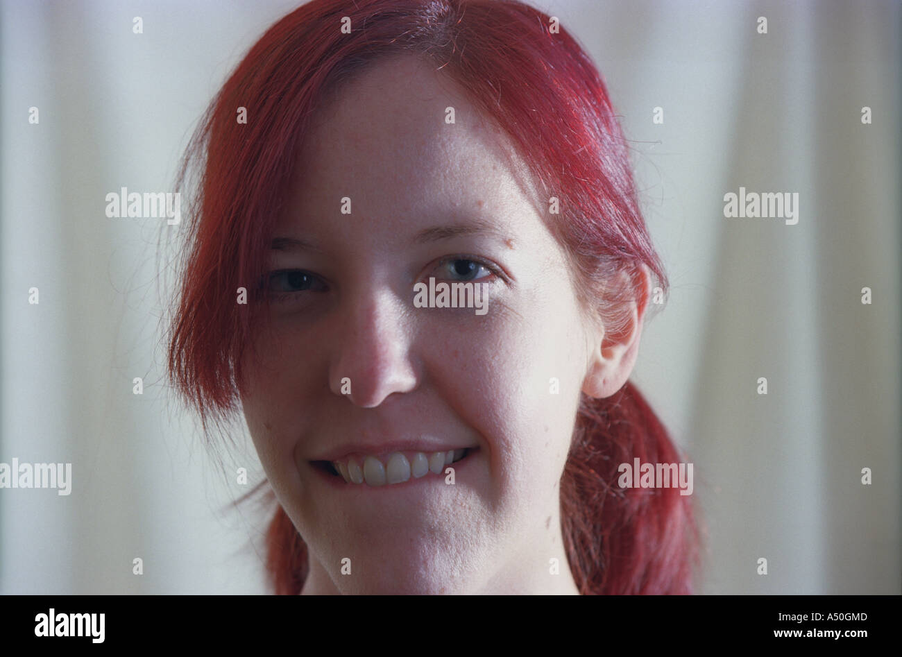 Studio portrait of a young woman with red hair Stock Photo - Alamy