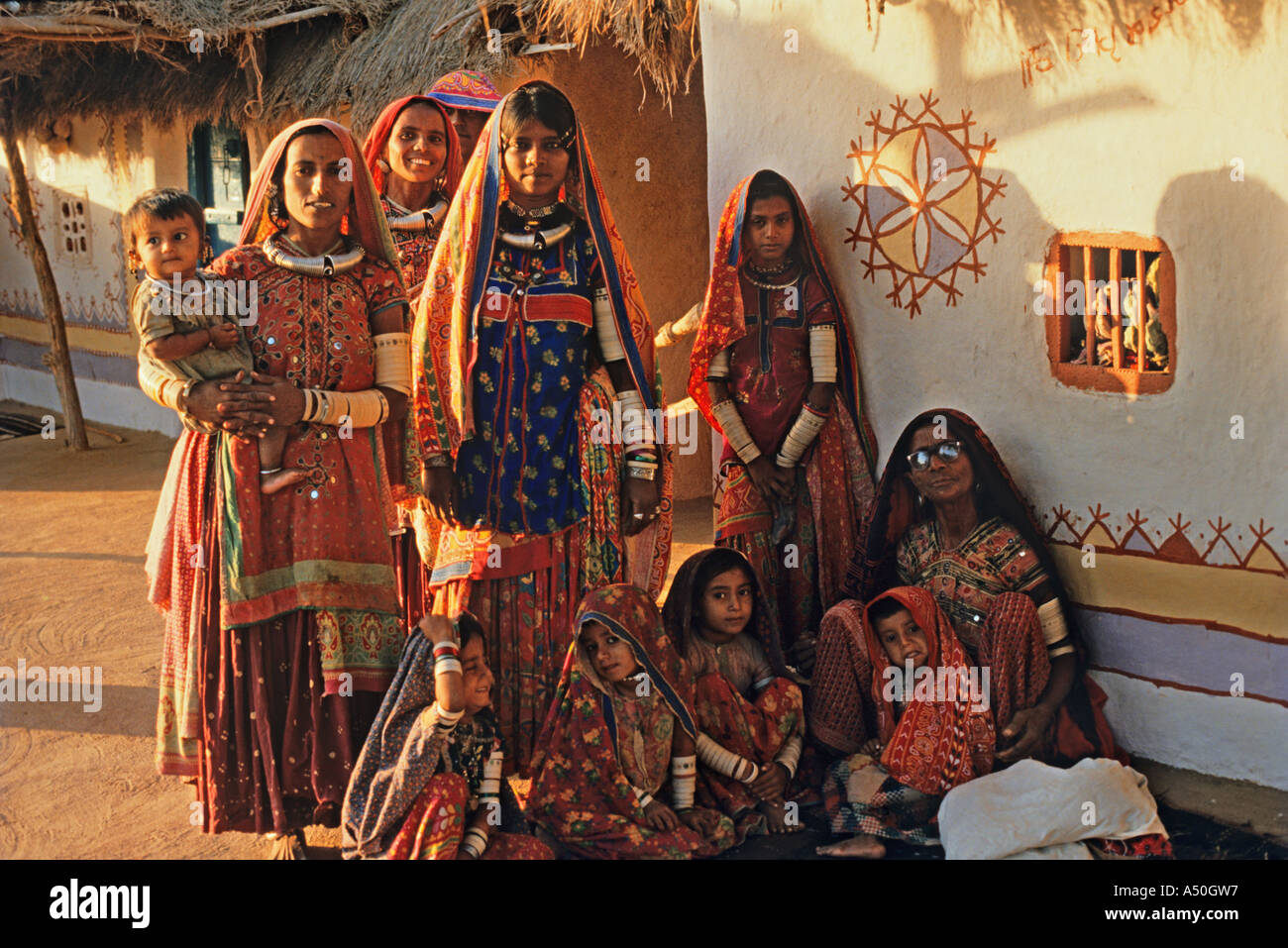 Kutch women standing outside a hut at Ku Stock Photo - Alamy