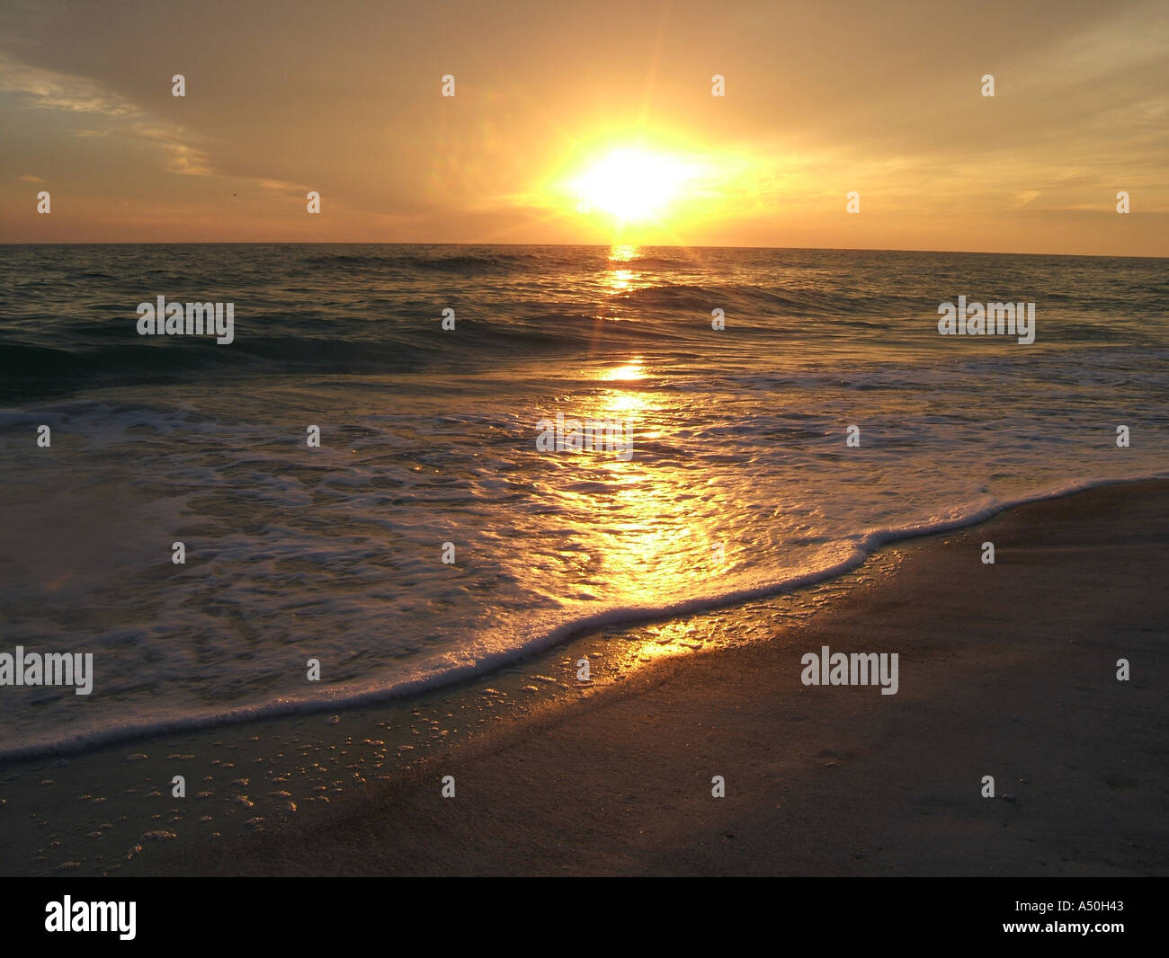sun setting over sea Stock Photo - Alamy
