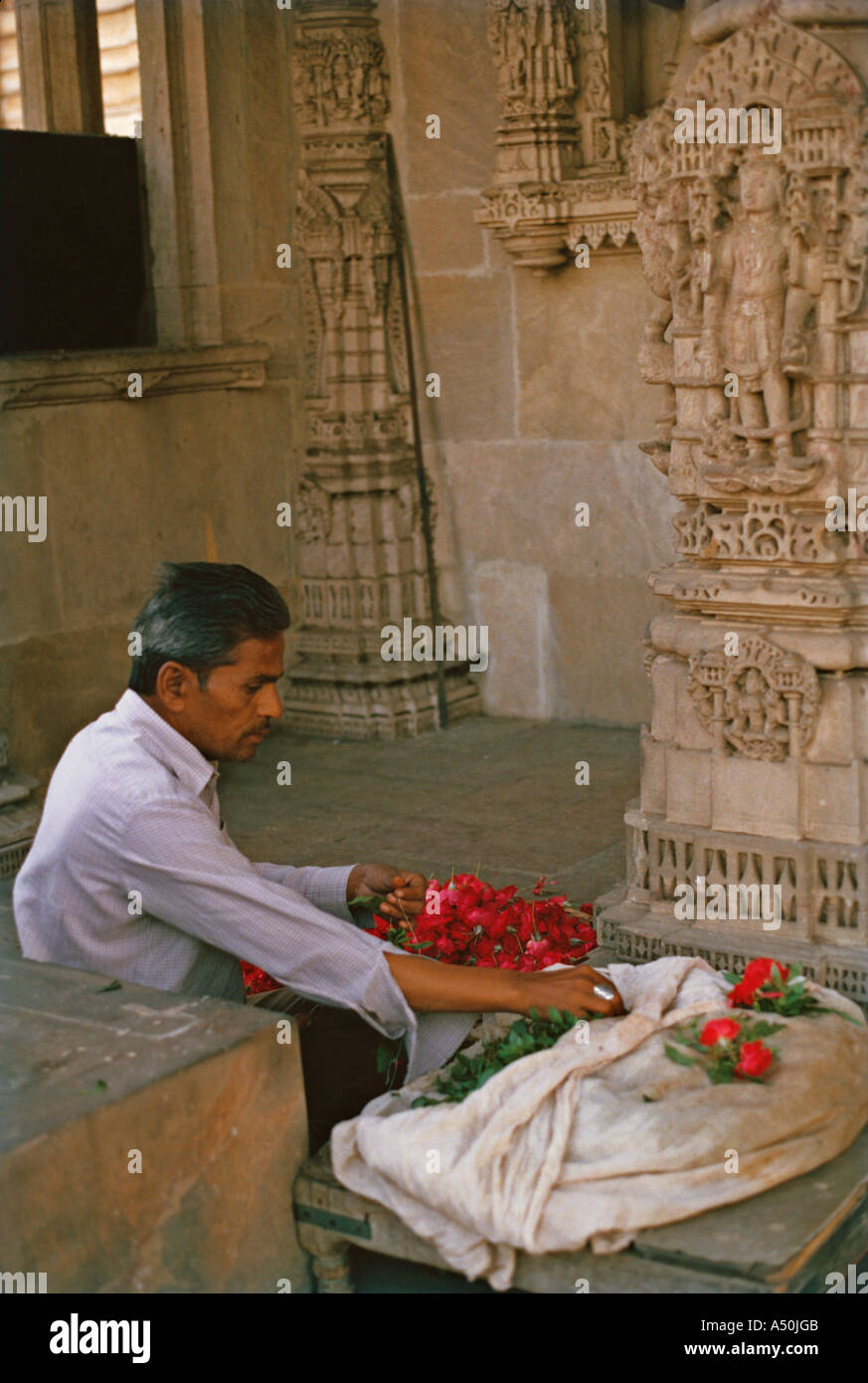 Man working at a temple Stock Photo - Alamy