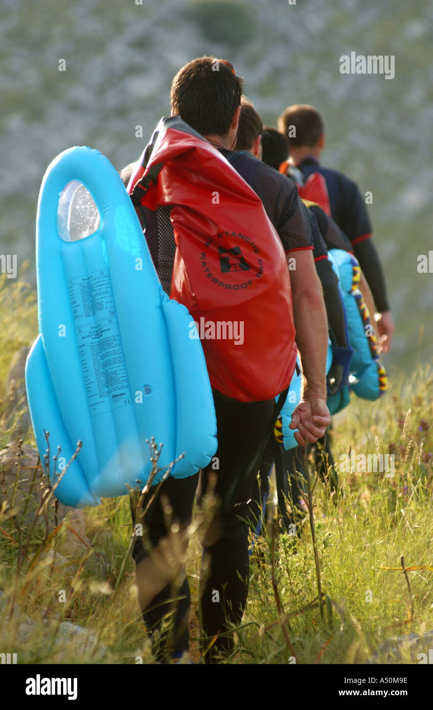 Adventure race athletes with inflatable airbeds for swim shaped like ...