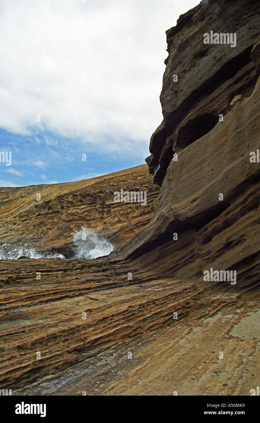 Eroding Hawaiian geological rock formation. Ocean tide rises in the ...