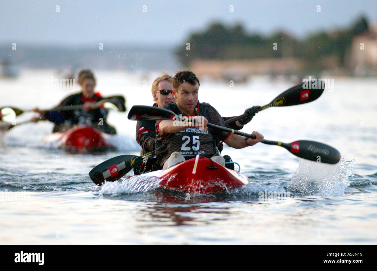 Adventure race athletes paddling kayaks Stock Photo - Alamy