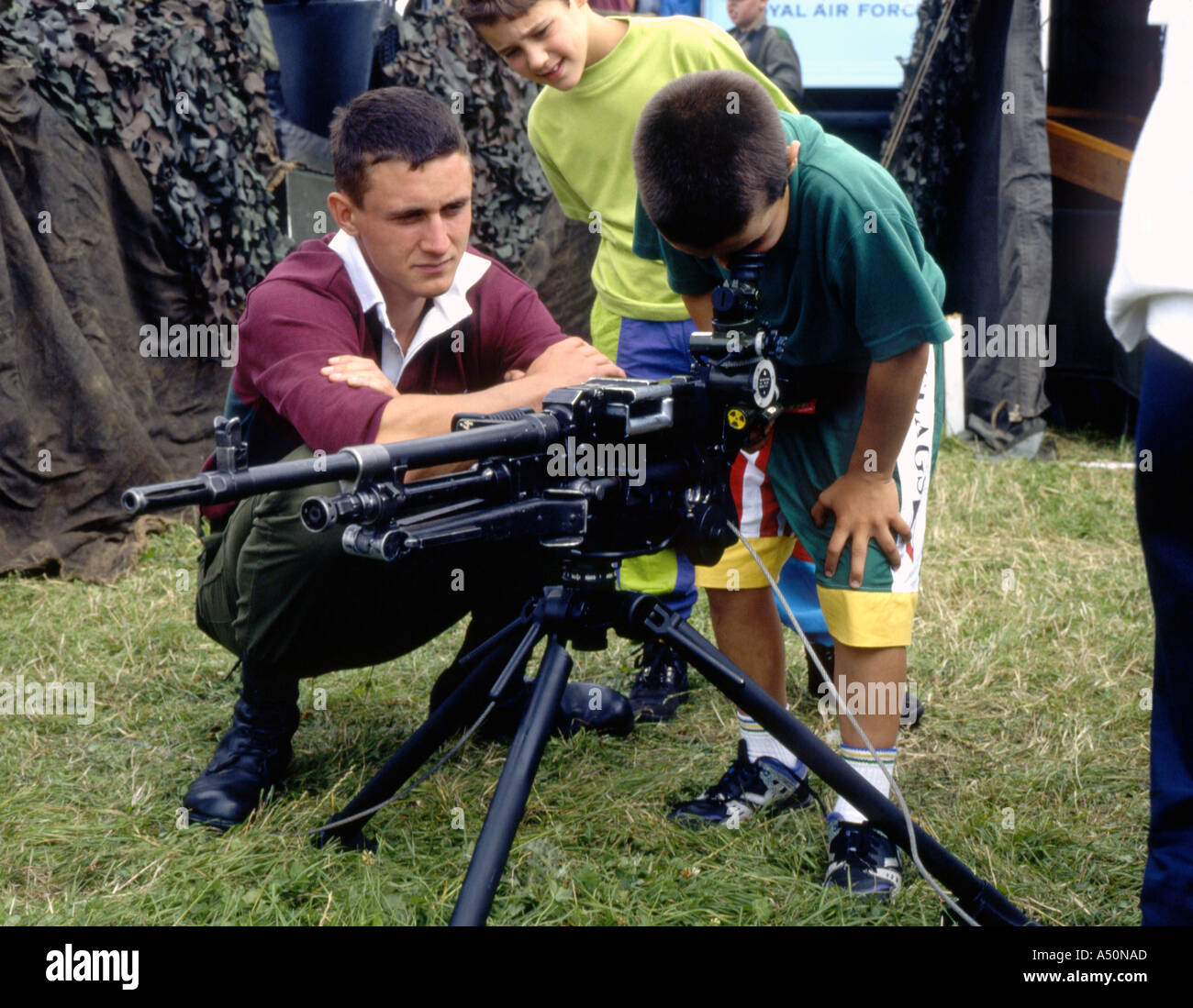 Boy being shown a general purpose machine gun at an RAF regiment ...