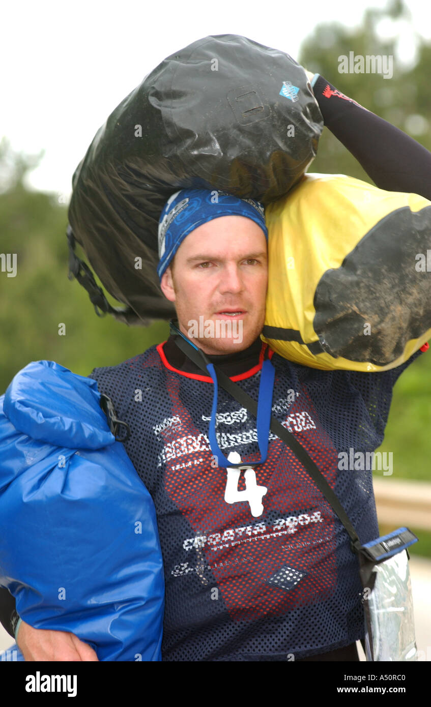 Adventure race athlete carrying heavy waterproof kit bags Stock Photo ...