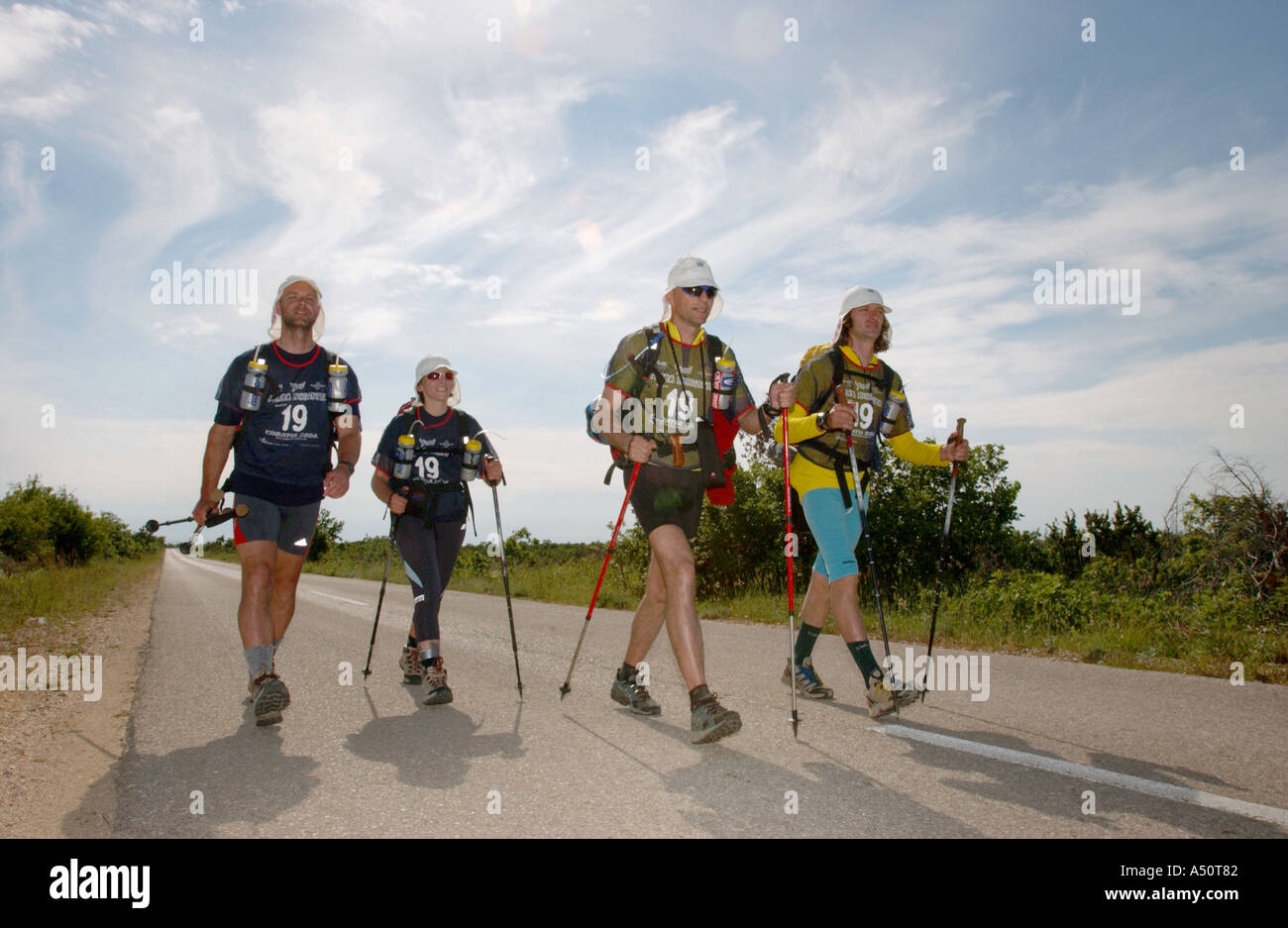 Adventure race team trekking in hot sun Stock Photo - Alamy