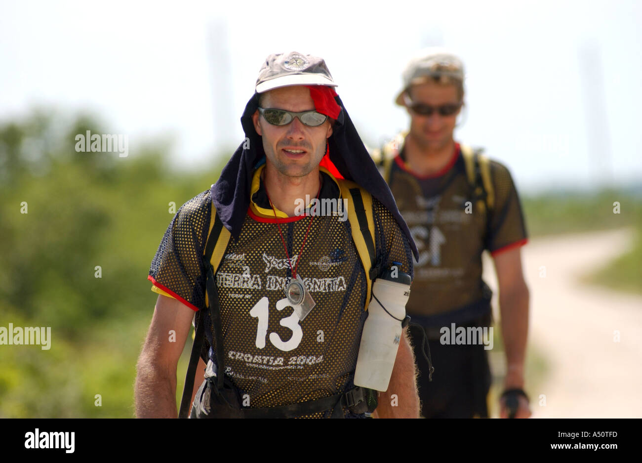 Adventure race team trekking in hot sun Stock Photo - Alamy