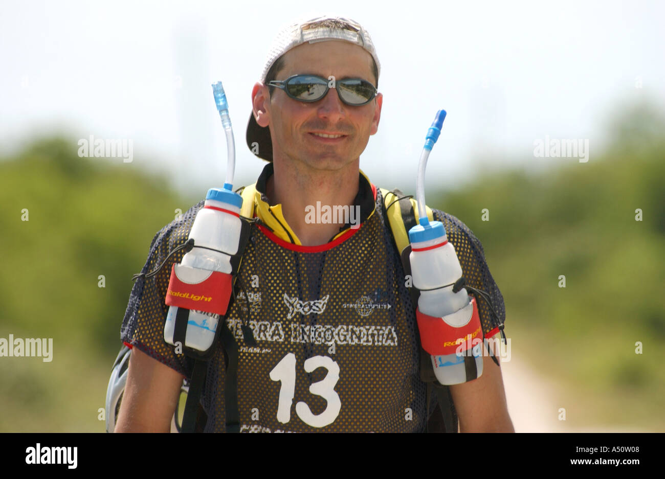 Adventure race athlete trekking in hot sun Stock Photo - Alamy