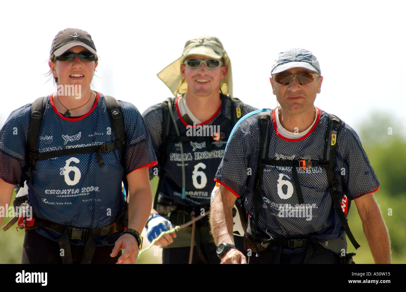 Adventure race team trekking in hot sun Stock Photo - Alamy
