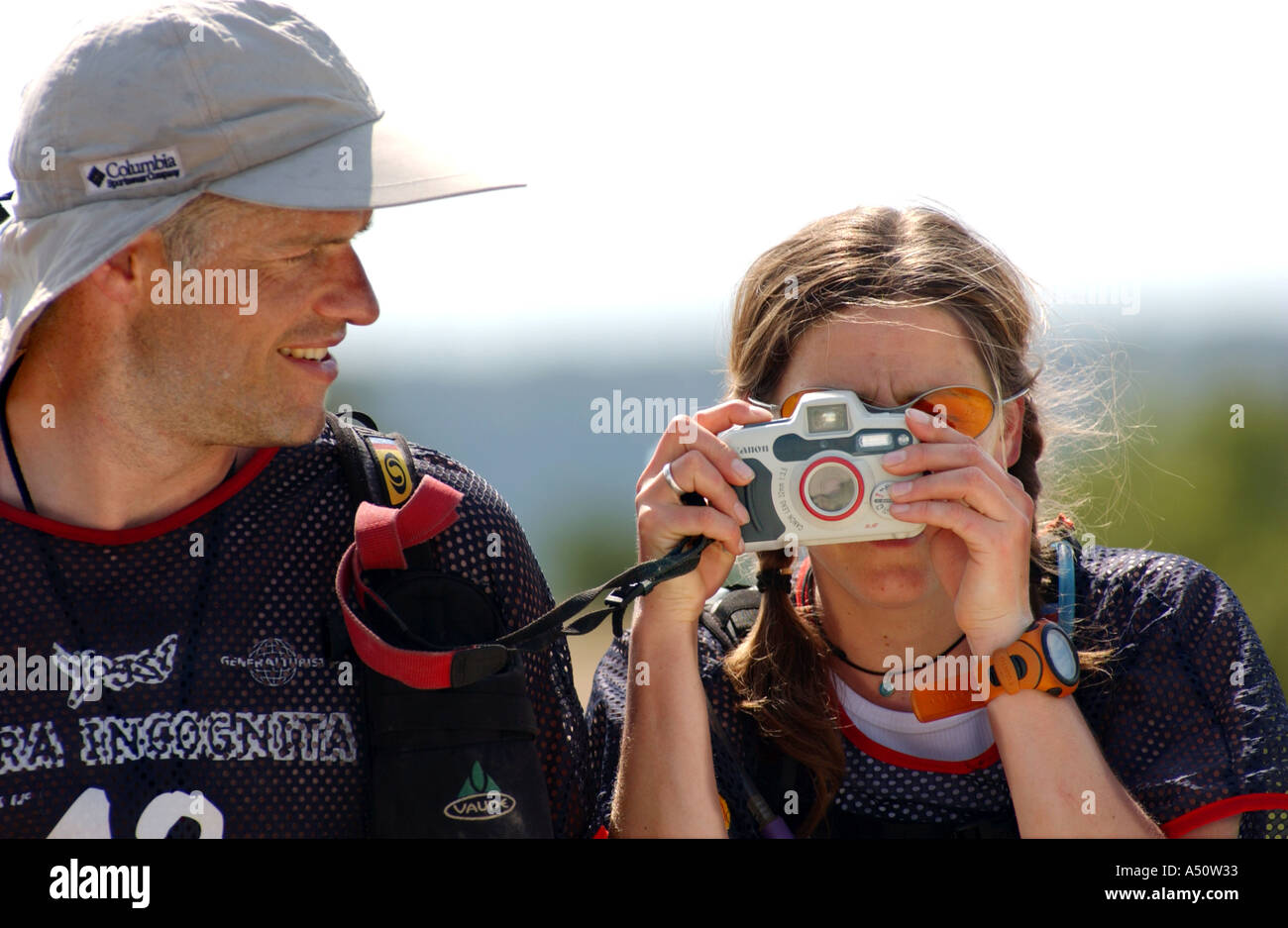 Female adventure race athlete takes photograph with waterproof camera ...