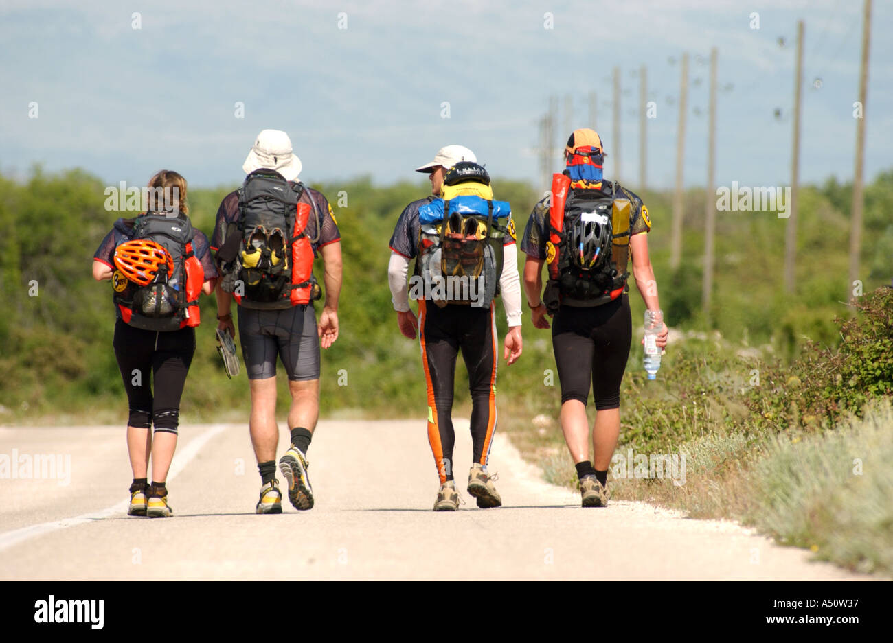 Adventure race team trekking in hot sun Stock Photo - Alamy