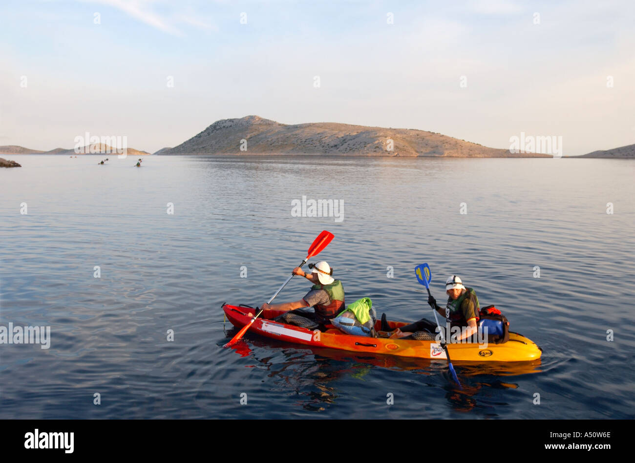 Adventure race athletes paddling kayaks Stock Photo - Alamy