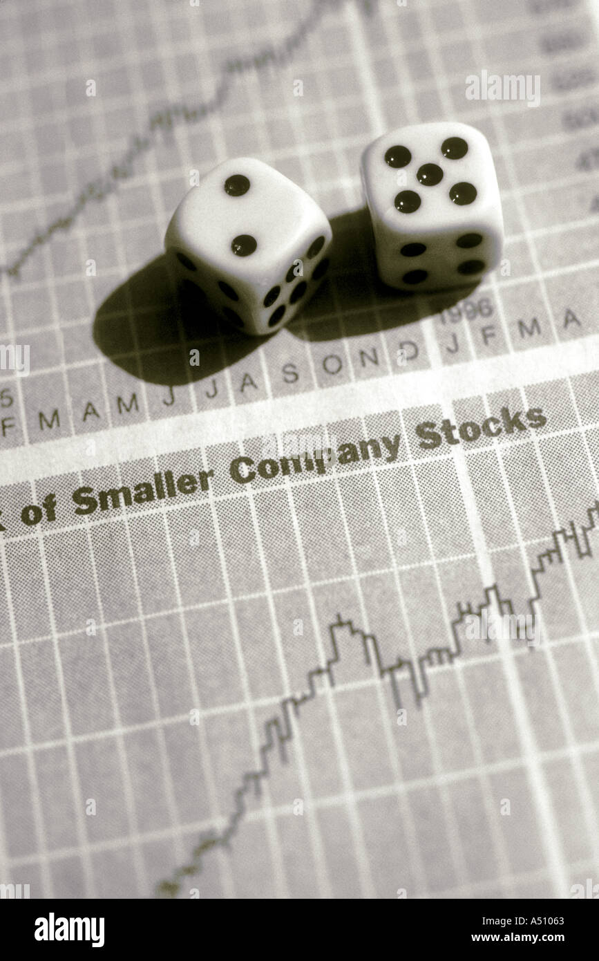 Two dice on finanicial perfomance chart in newspaper Stock Photo - Alamy