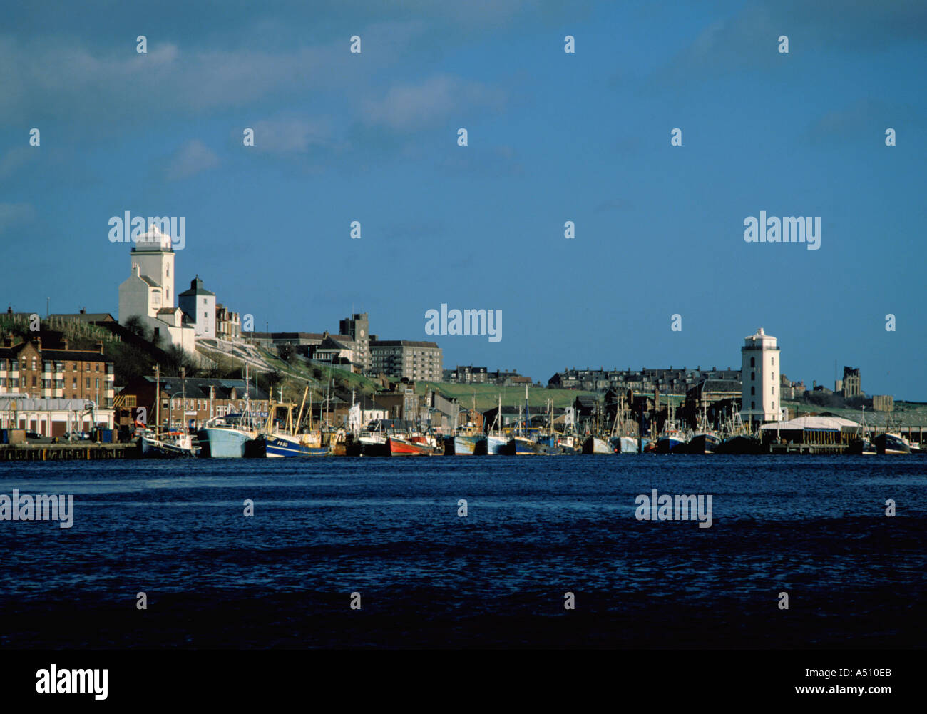 General view of fishing boats at the fish quay, and leading lights ...