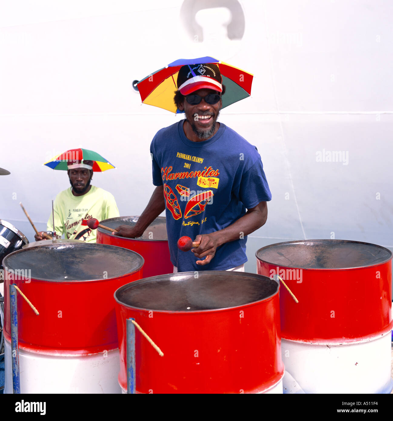 Two steel band musicians wearing mini sun brollies play to welcome ...