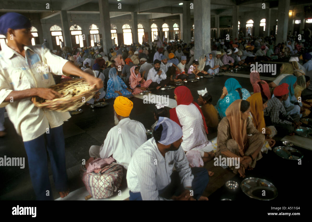 Group of people eating langar community kitchen Golden Temple Stock ...