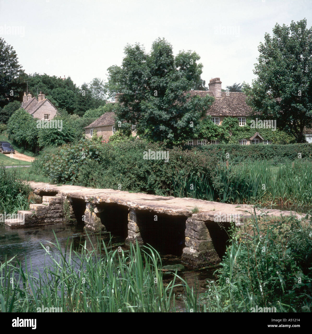 The Ancient clapper bridge, And, River Leach at Eastleach ...