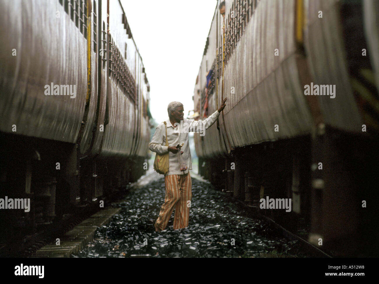 Man standing between Trains Stock Photo - Alamy