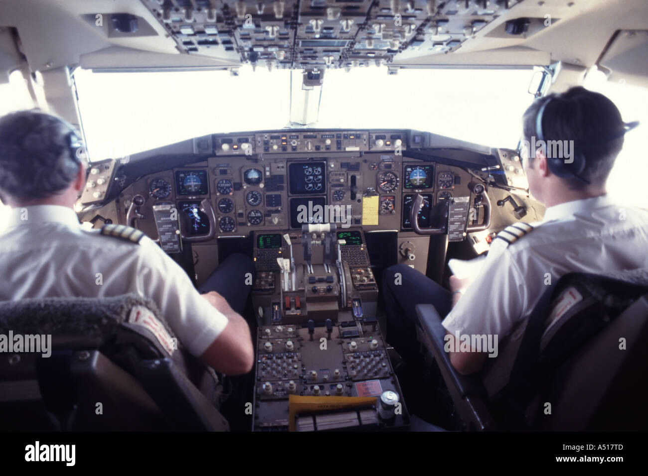 Pilot and co pilot on flight deck of passenger jet airliner pre flight ...