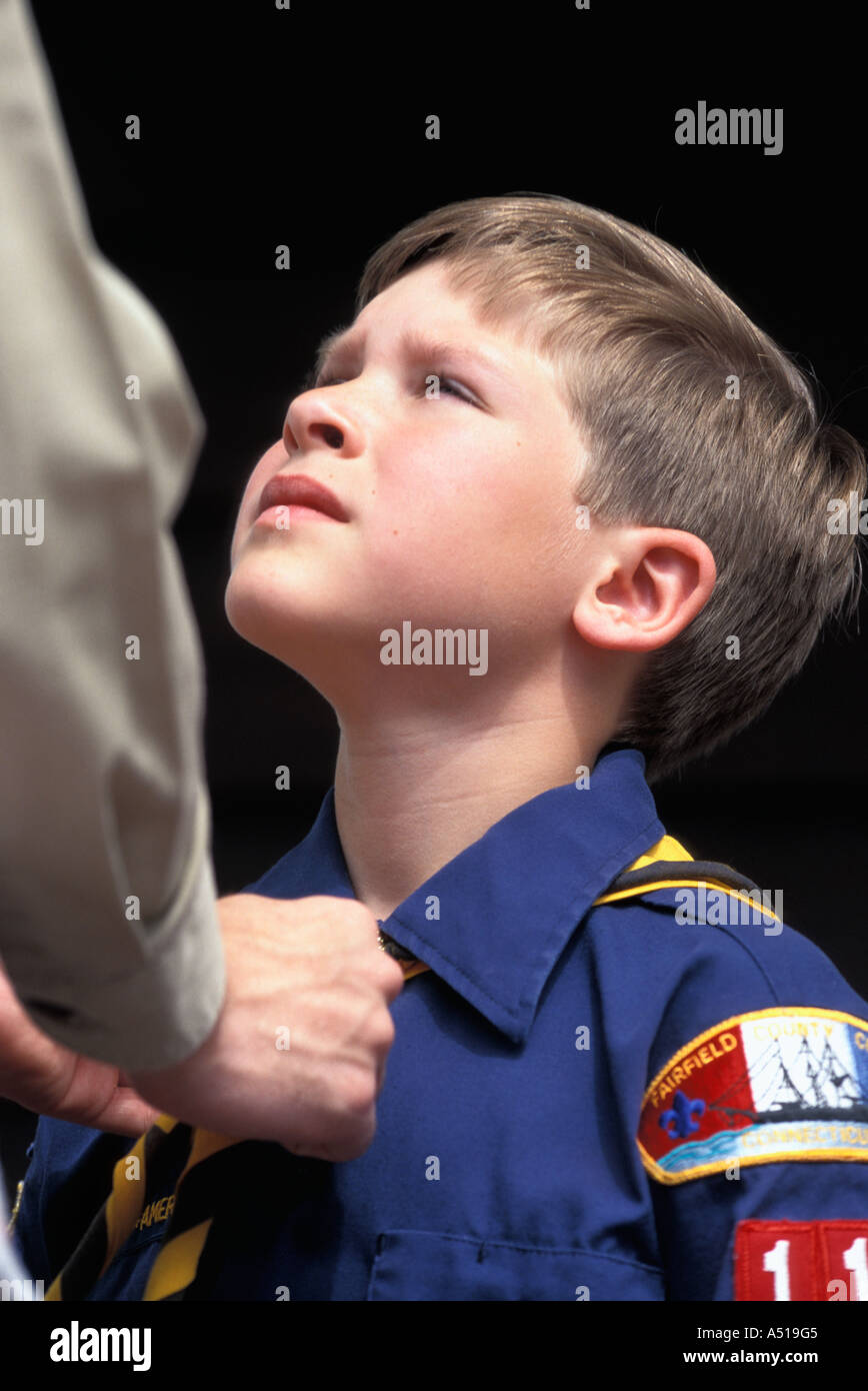 Boy Scout straightening neckerchief of Cub Scout User needs to obtain ...