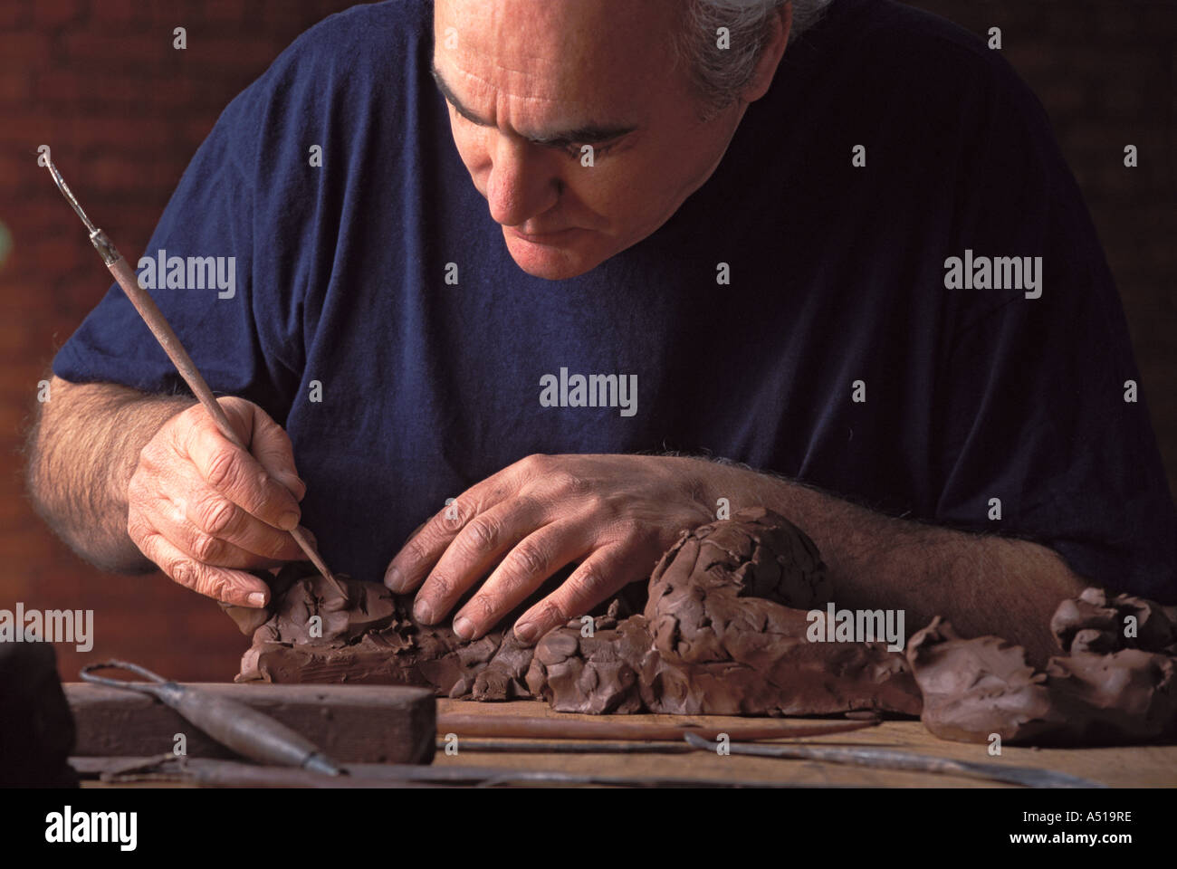 sculpture working with clay Stock Photo - Alamy