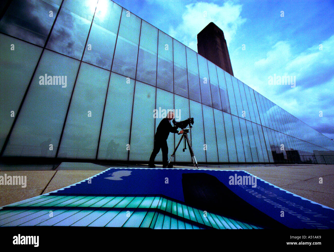 A photographer with tripod on the roof of Tate Modern art gallery ...