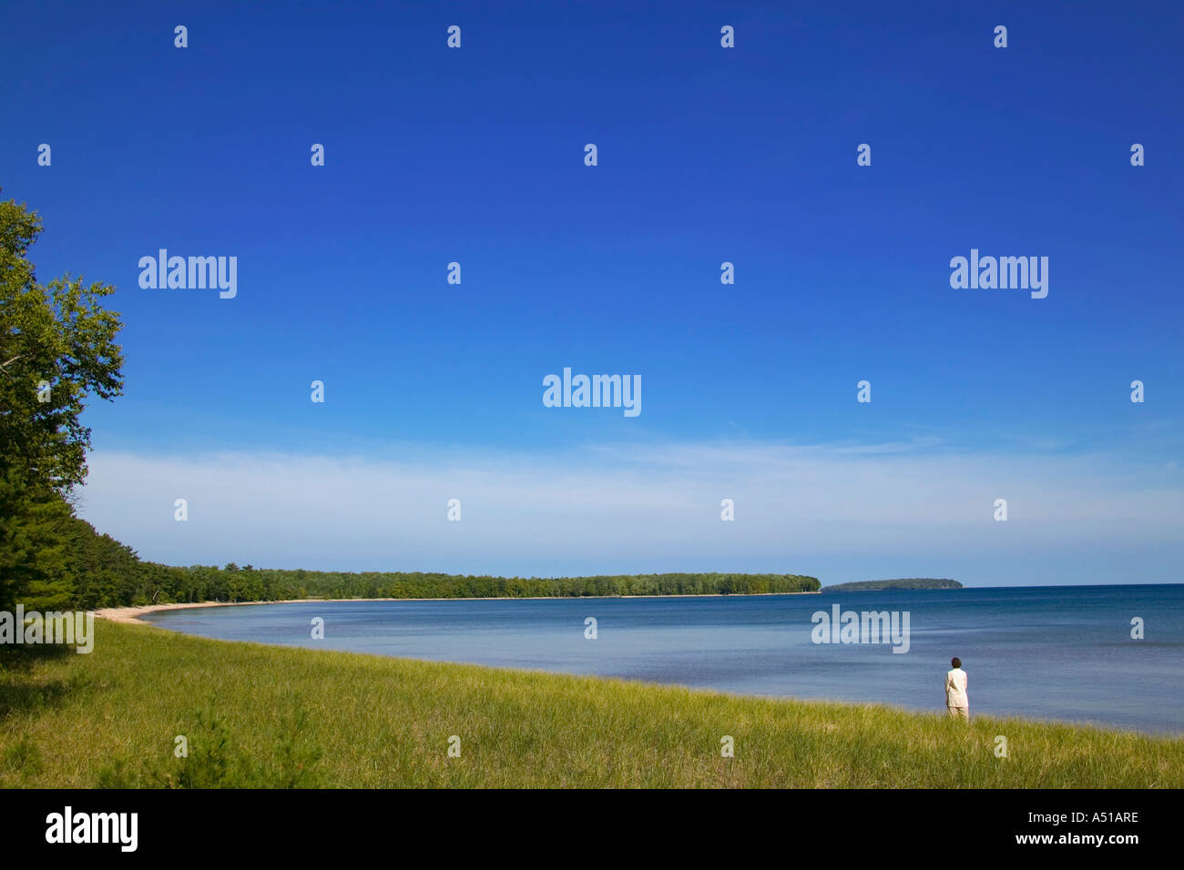 Person looking out at water in bay Stock Photo - Alamy