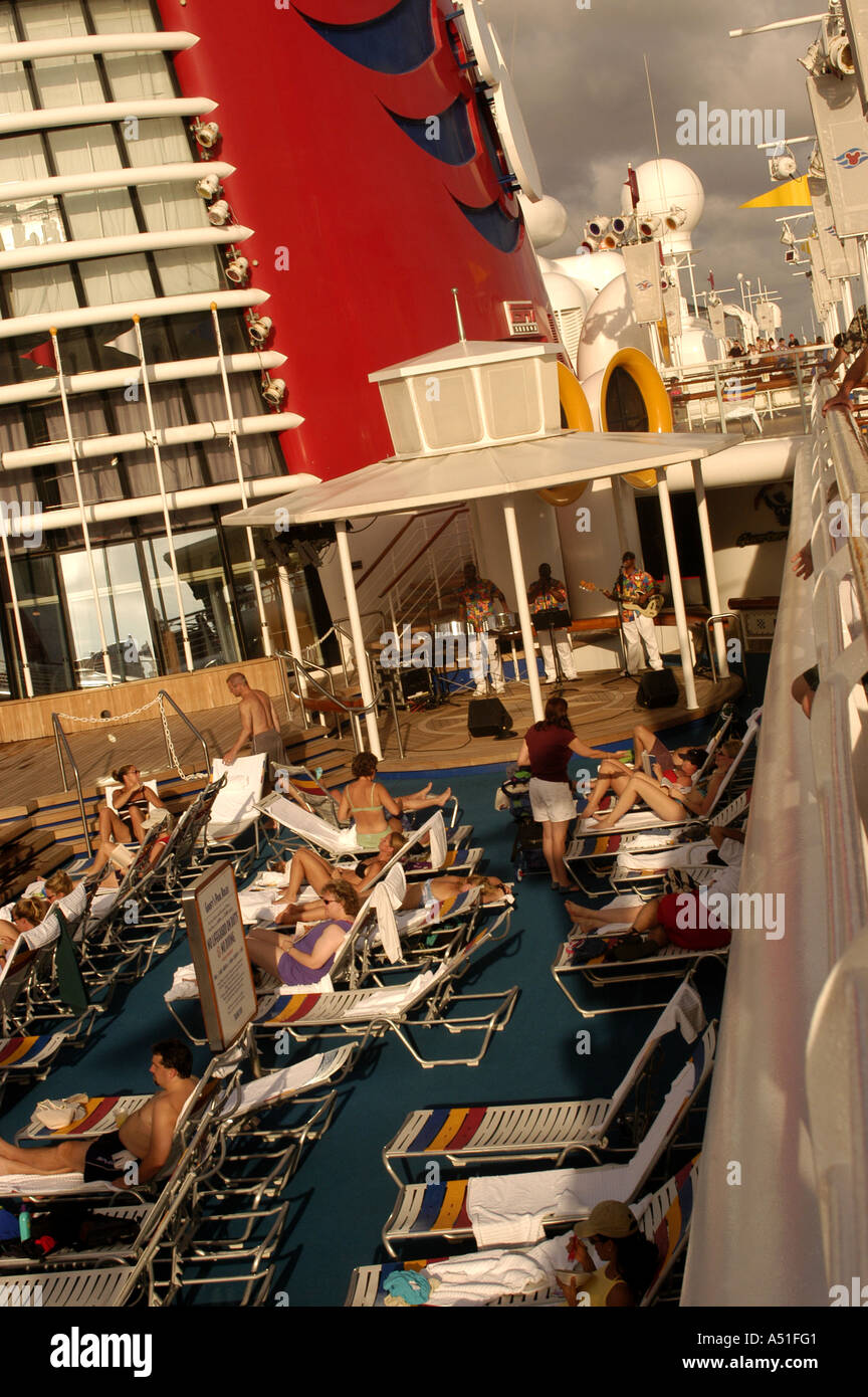 Cruise Ship Disney Wonder pool deck with adults in deck chairs bright ...