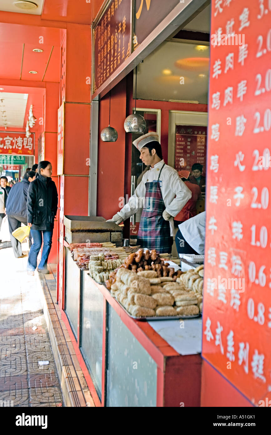 CHINA BEIJING Chef preparing kabobs and other street food at open air ...