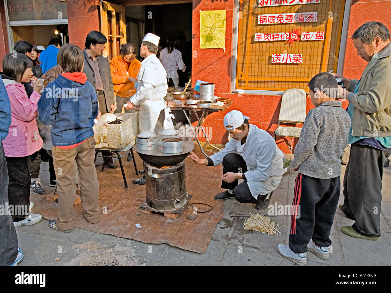 CHINA BEIJING Tiny but busy neighborhood restaurant with chefs set up ...