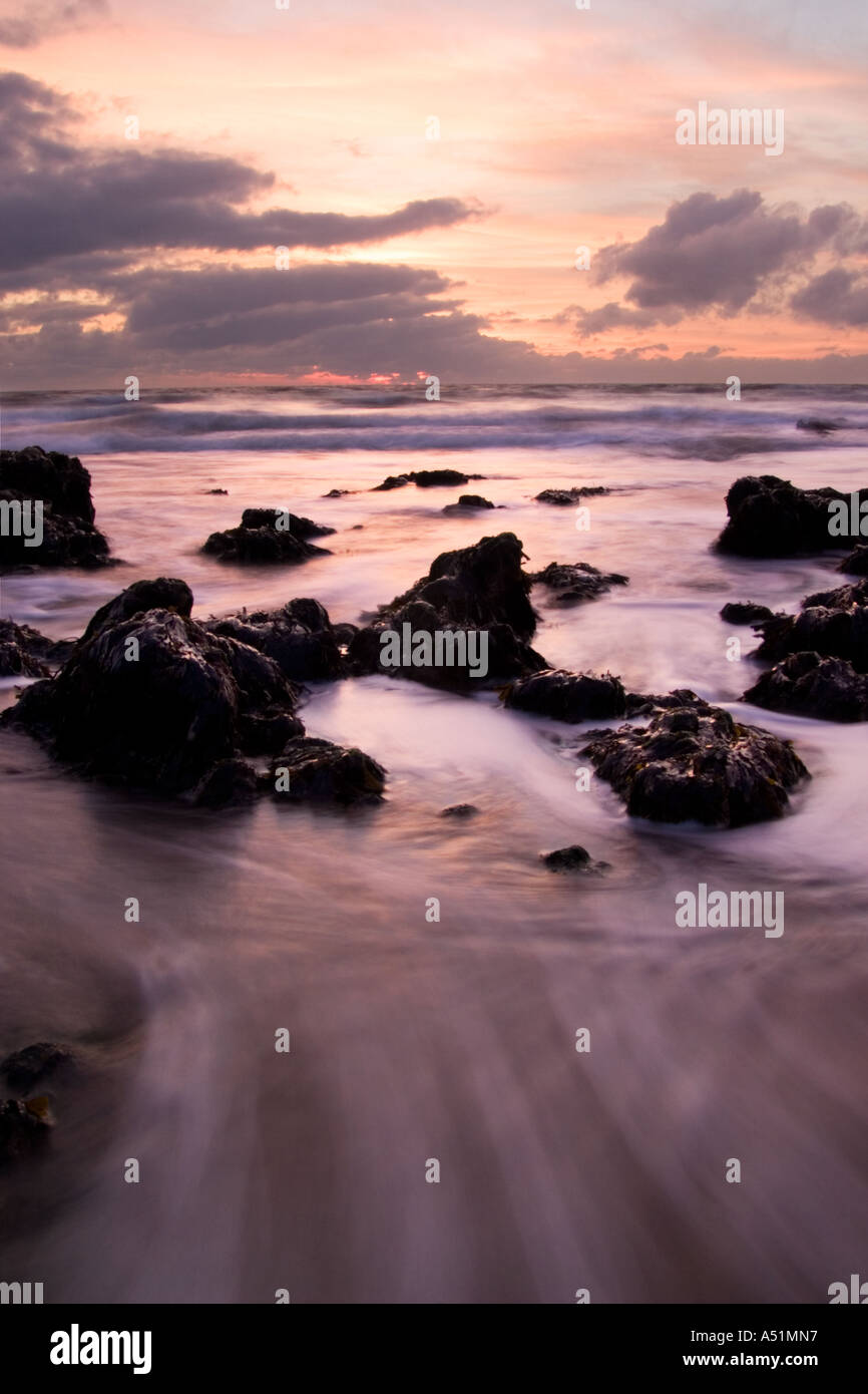 Sunset on Compton Beach slow exposure showing flow of sea amongst rocks ...
