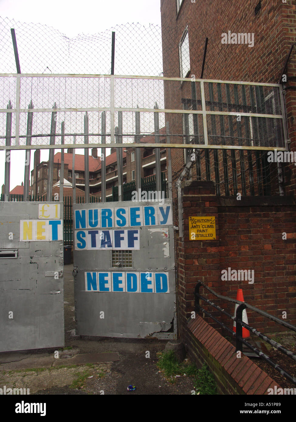 Nursery staff needed poster on metal doors with security fencing and ...
