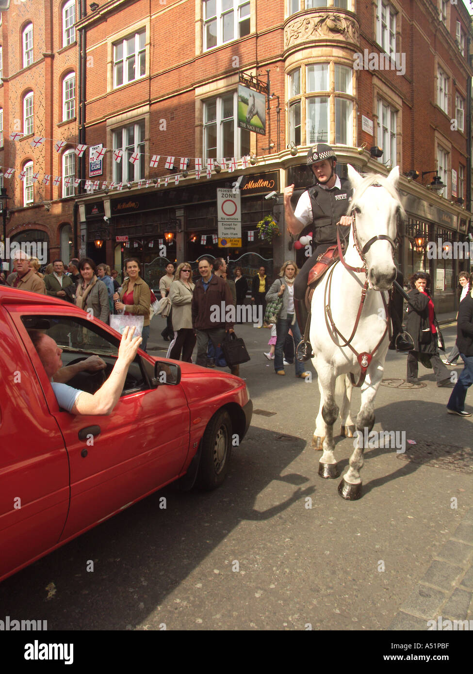 Policeman on white horse talking with angry man in red van Covent ...