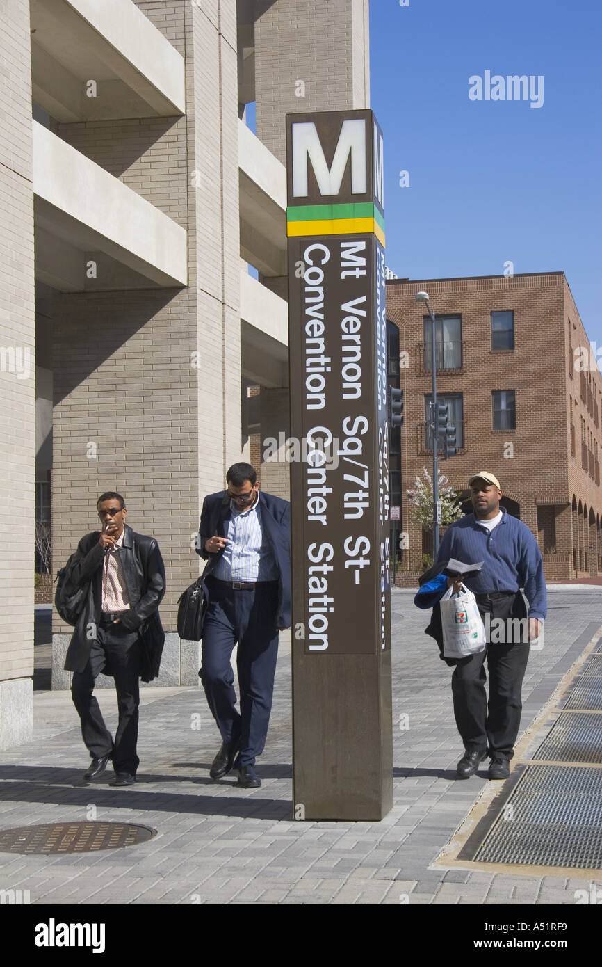 Three men walking past entrance sign at Mt Vernon Square Convention ...