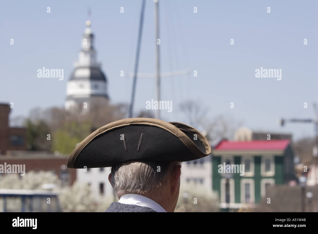 Certified Colonial guide wearing three cornered hat stands near the ...