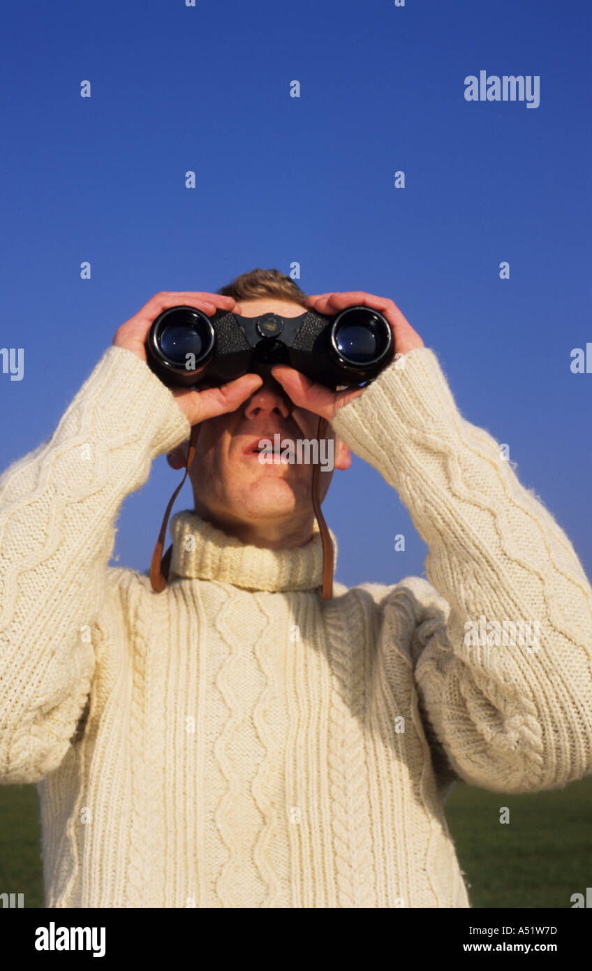 man using binoculars in the countryside yorkshire uk Stock Photo - Alamy