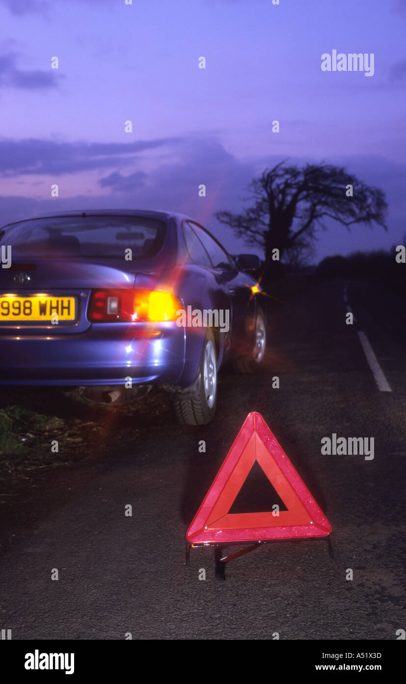 hazard warning triangle by broken down car on country road near leeds ...