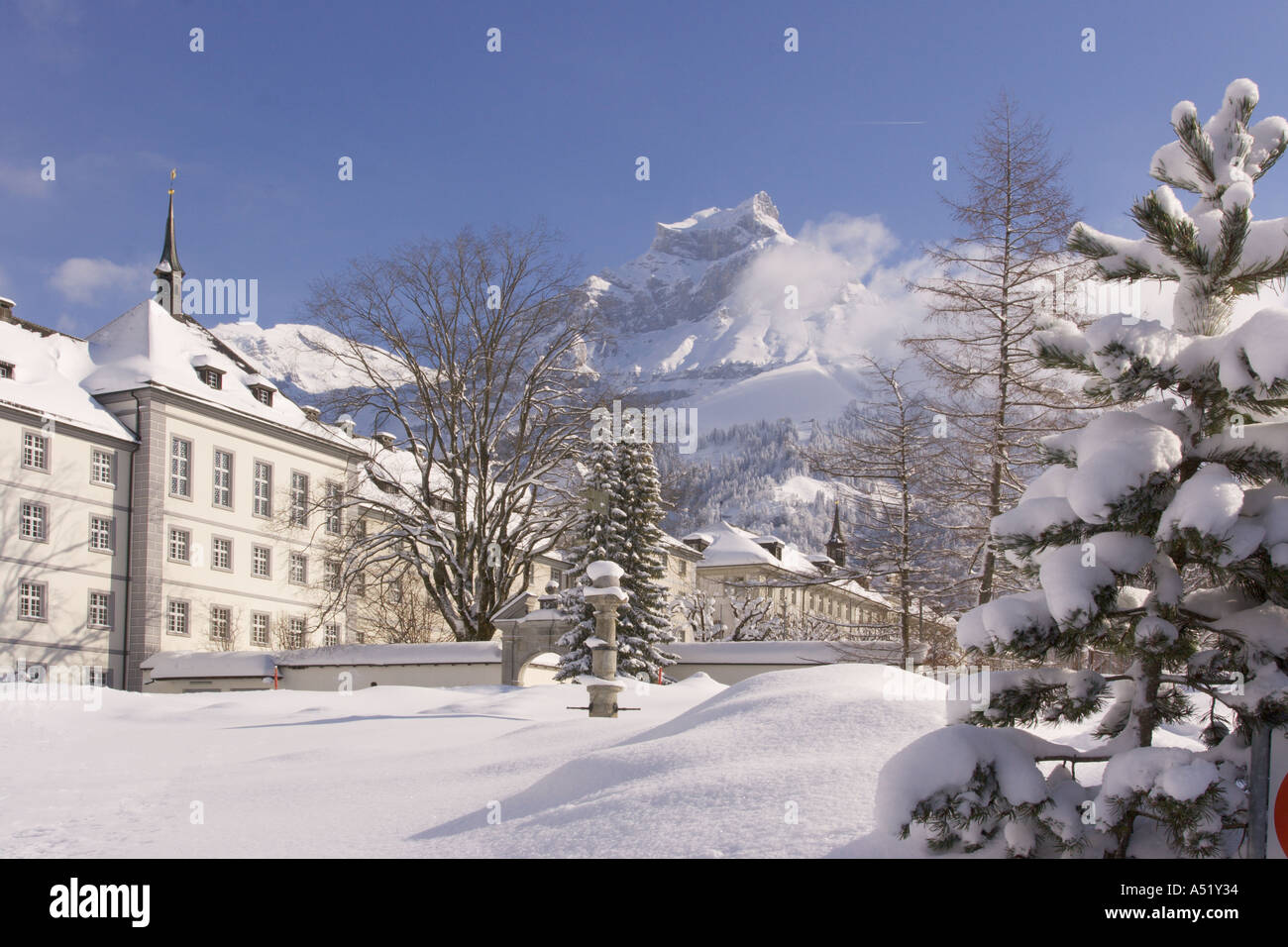 The Benedictine Monastery and grounds in deep snow textured in sunlight ...